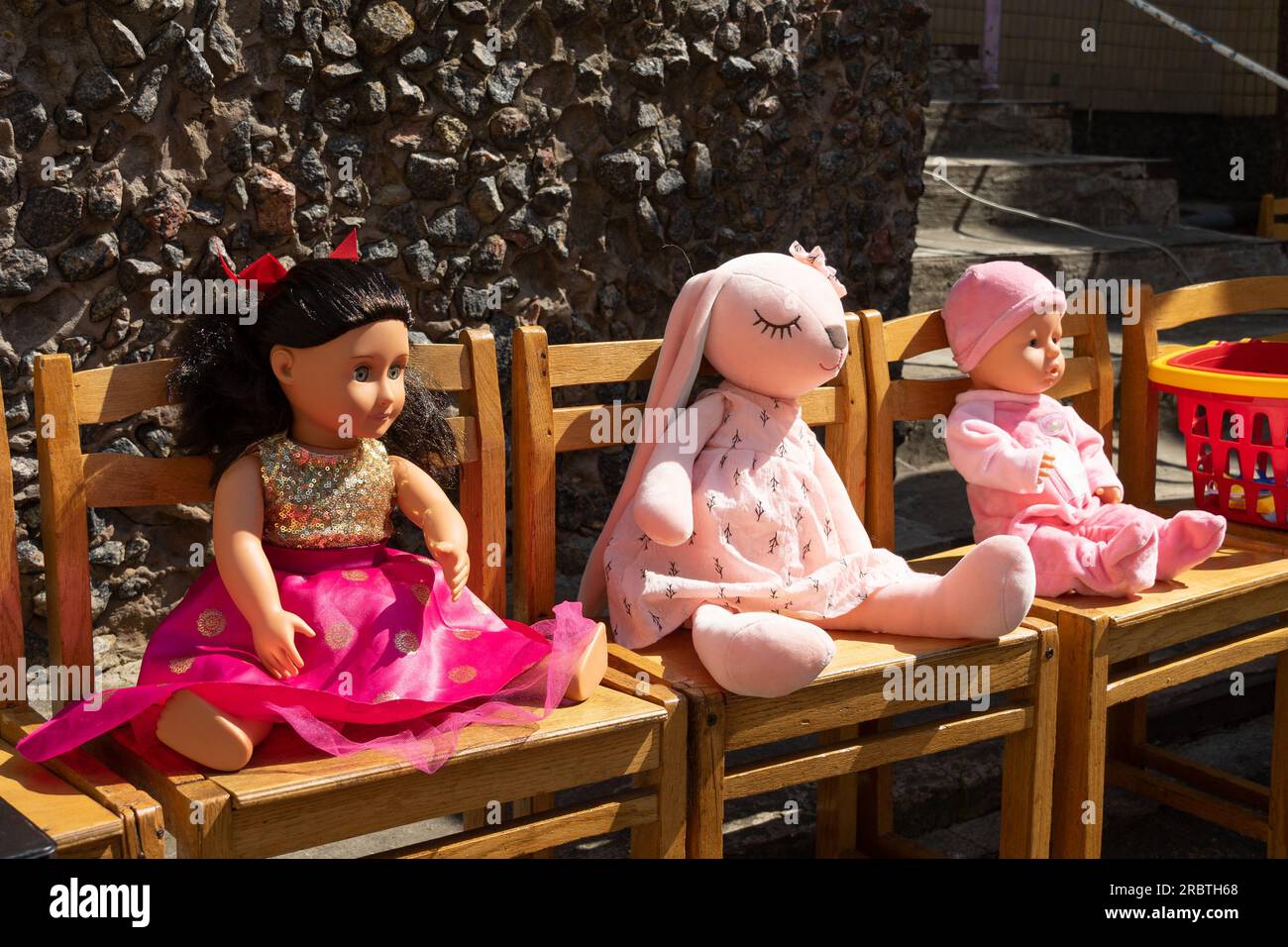 Large children's doll and soft toy. A doll and a soft toy are sitting ...