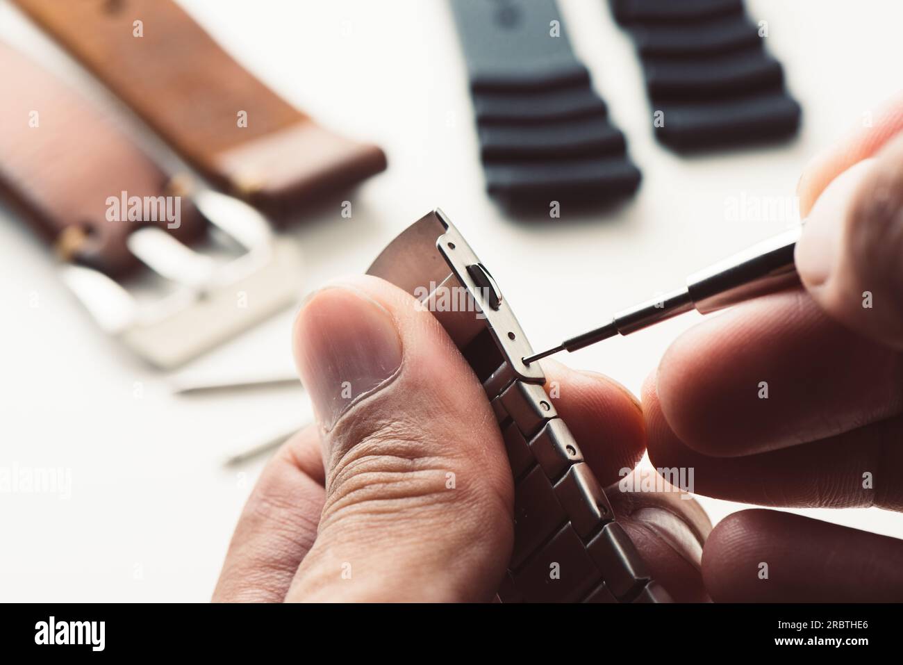 Watchmaker using spring bar tool. Spring bar tool used to remove spring ...