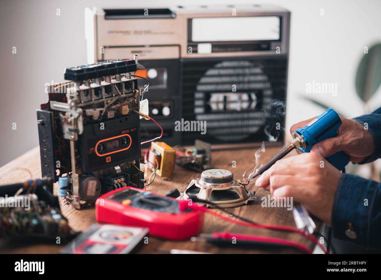 Technician repairing an old radio cassette recorder Stock Photo - Alamy