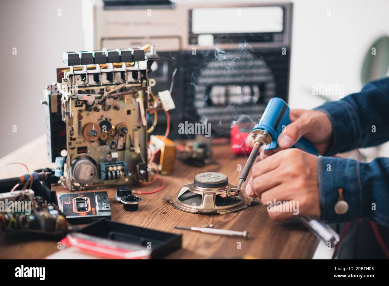 Technician repairing an old radio cassette recorder Stock Photo - Alamy