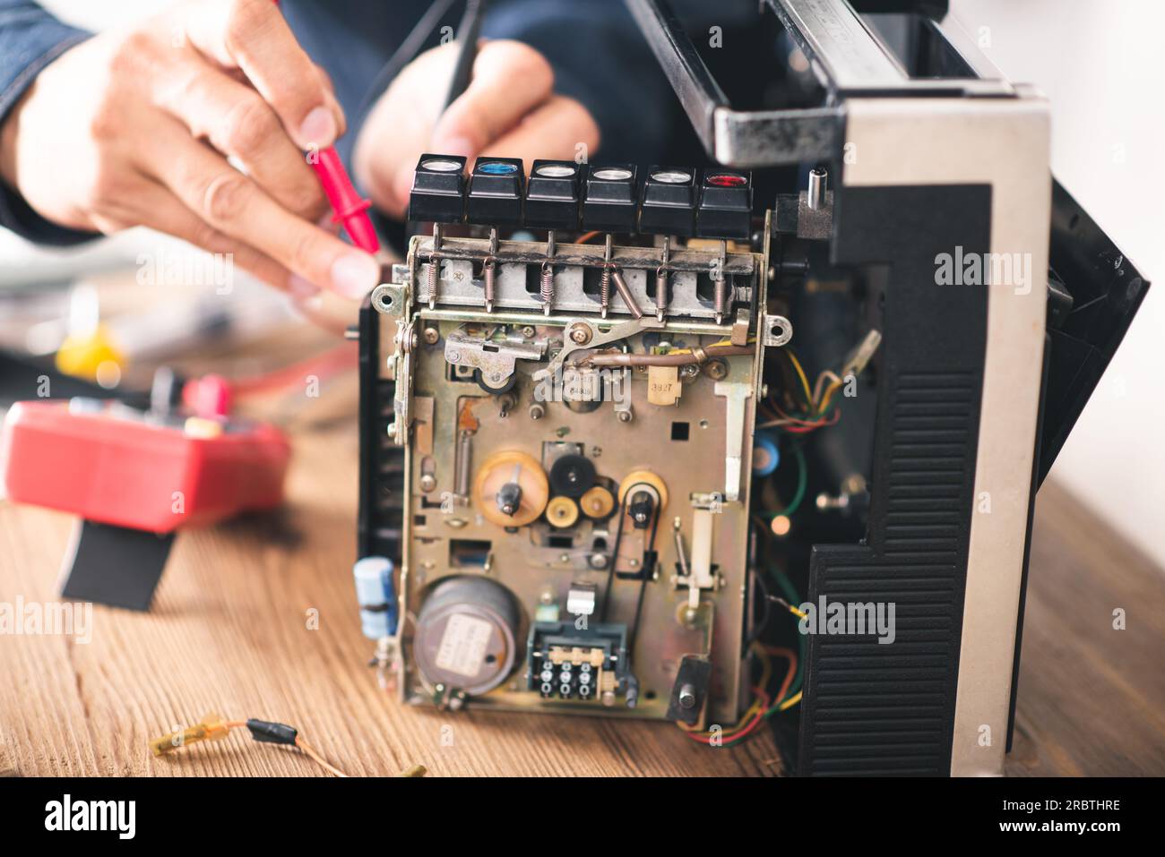 Technician repairing an old radio cassette recorder Stock Photo - Alamy