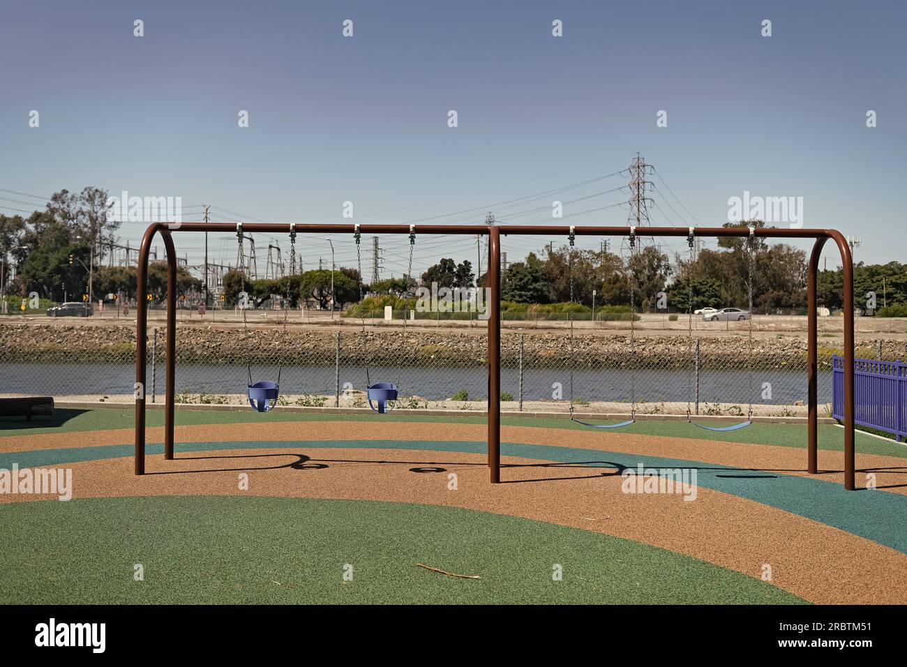 Metal four seat swings outdoors. Childrens swings on playground. Swings ...