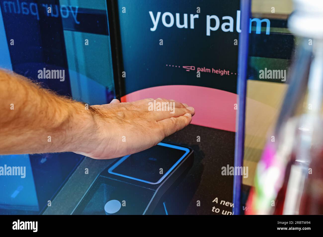 Close-up of male hand scanning his palm to pay with modern wireless ...