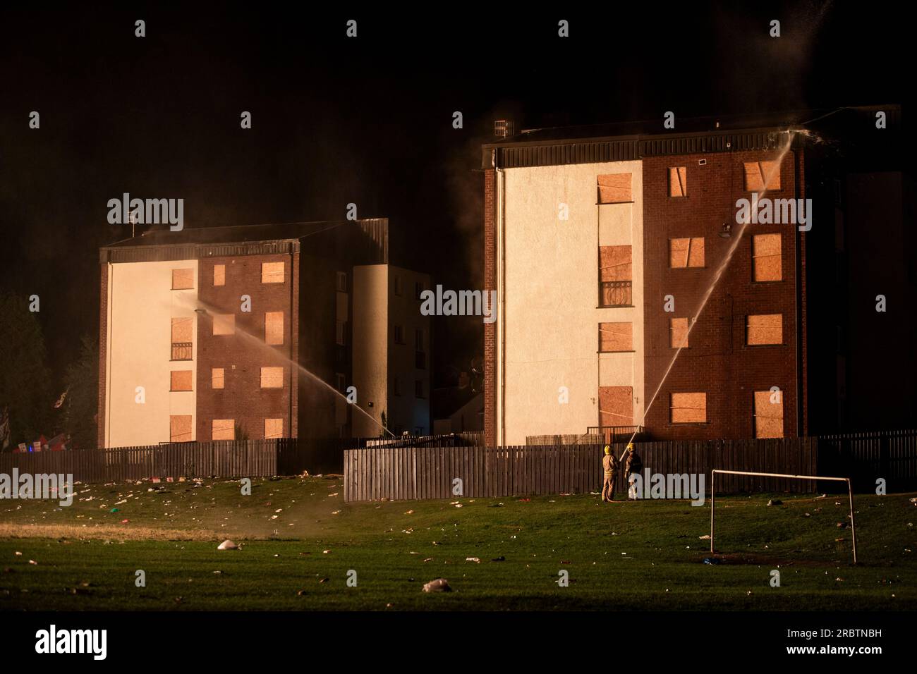 Firefighters from Northern Ireland Fire and Rescue Service hose down ...