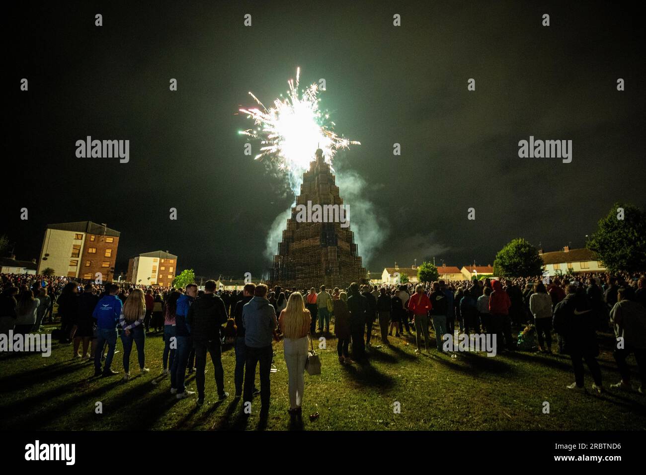 People watch the burning of the loyalist Corcrain bonfire in Portadown ...