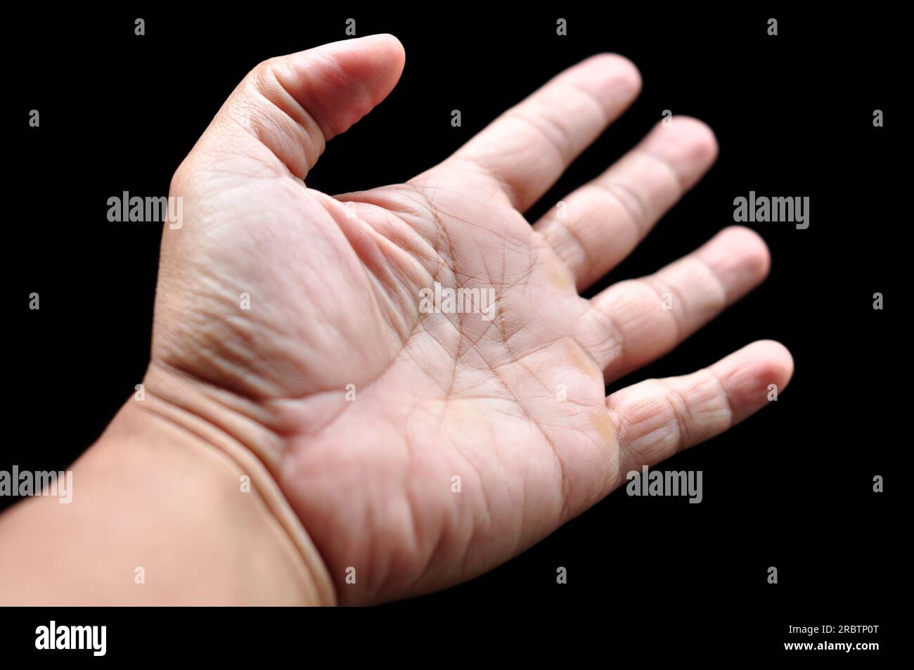 Asian man palms wide open fingers black background Stock Photo - Alamy