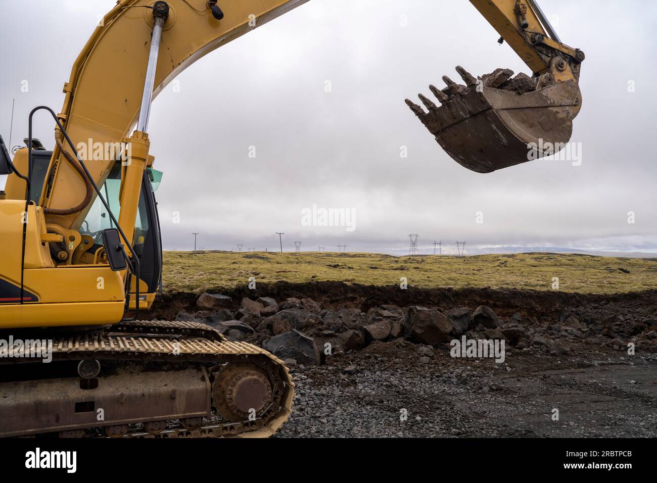 Excavator with Digging bucket in Vulcanic active area Stock Photo - Alamy