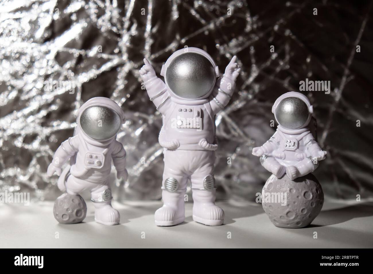 Three Plastic toys figure astronaut on silver background Copy space ...
