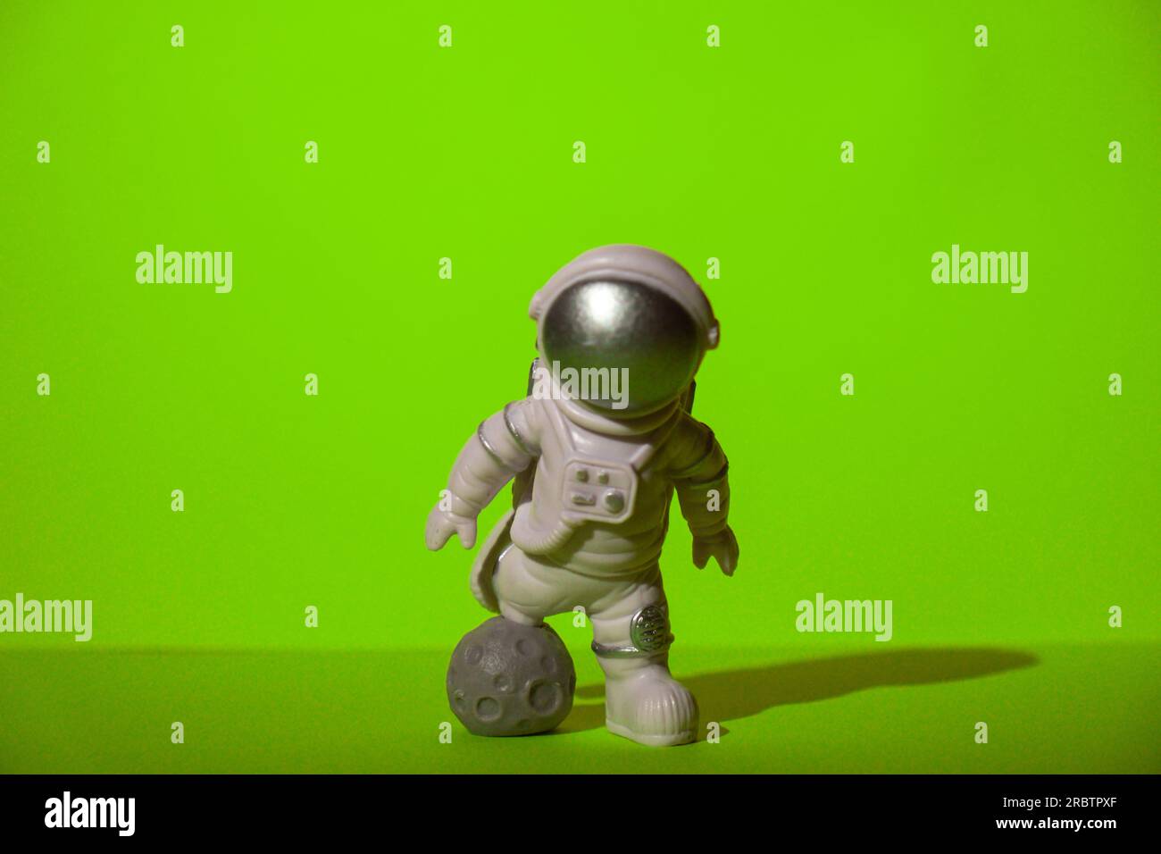 Plastic toy astronaut on green chroma key background Template Mock up ...