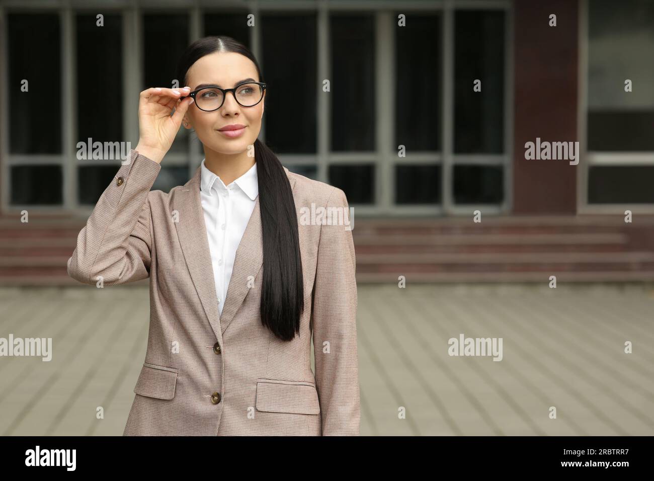 Beautiful real estate agent in nice suit outdoors, space for text Stock ...