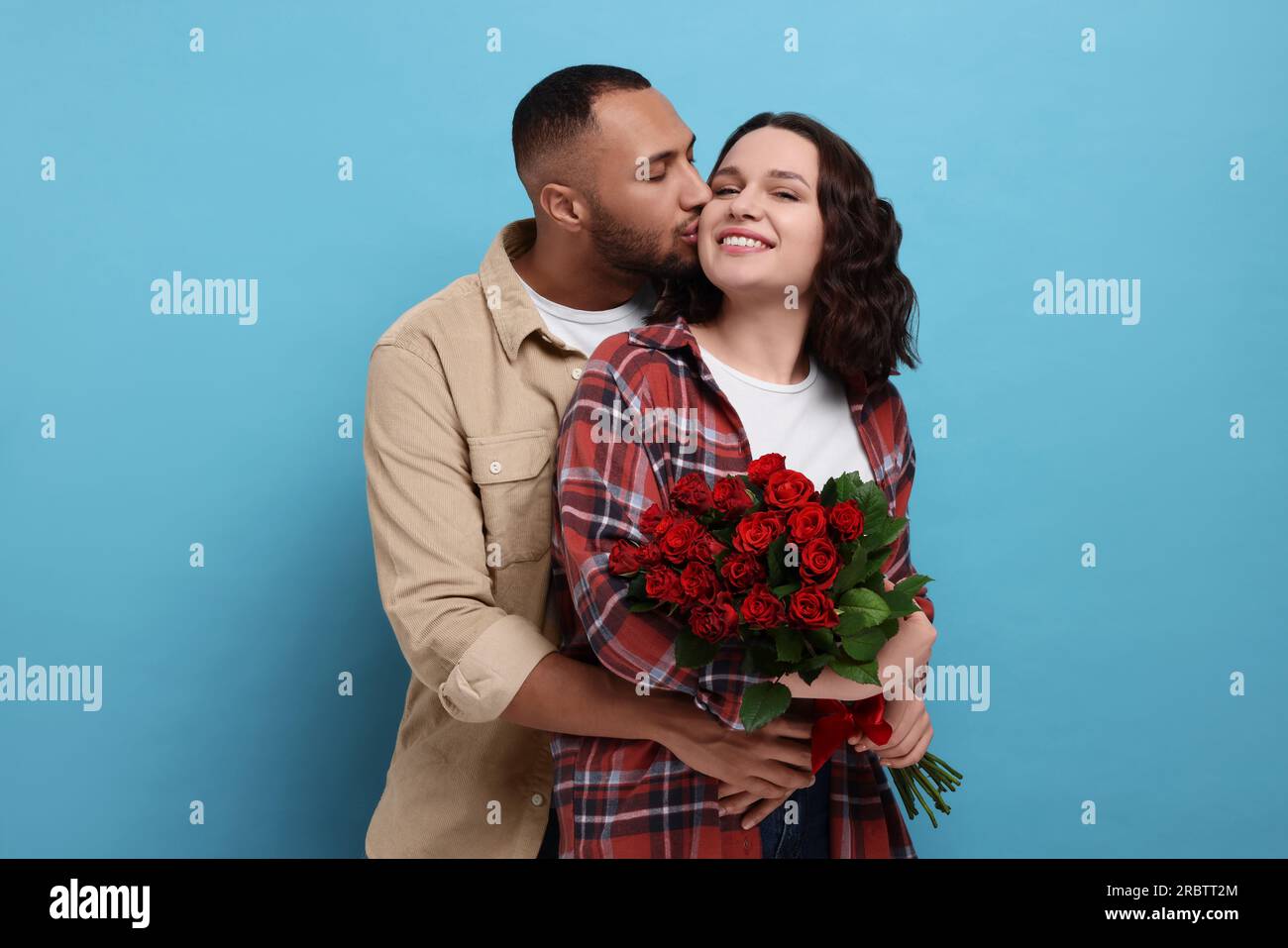 Happy couple celebrating Valentine's day. Beloved woman with bouquet of ...