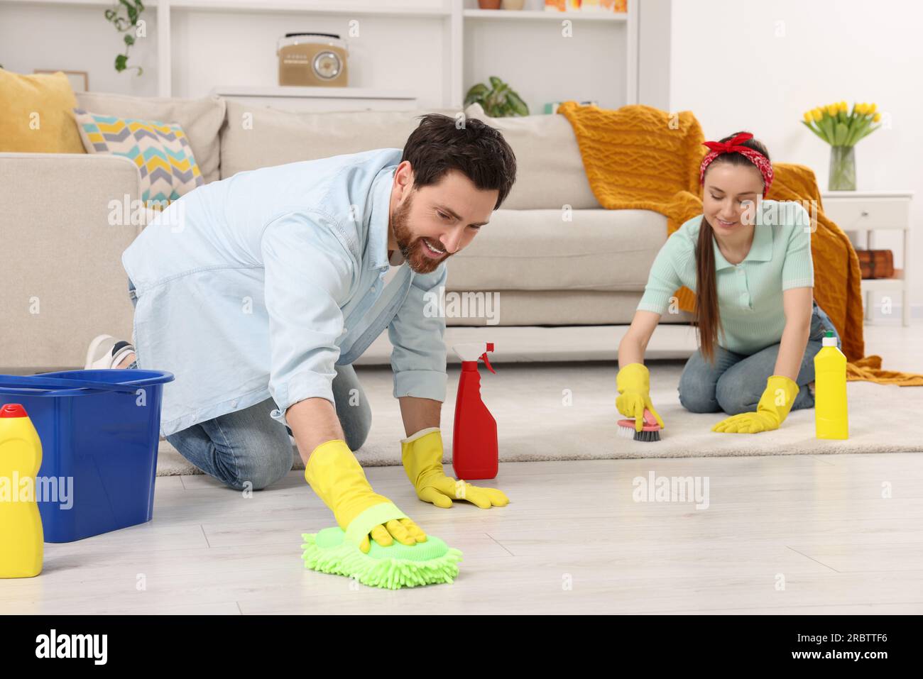 Spring cleaning. Couple tidying up living room together Stock Photo - Alamy