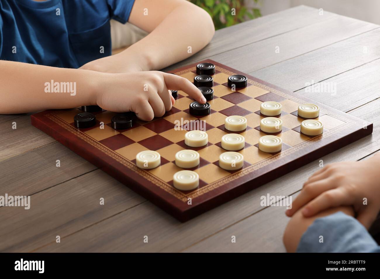 Kid learning checkers hi-res stock photography and images - Alamy