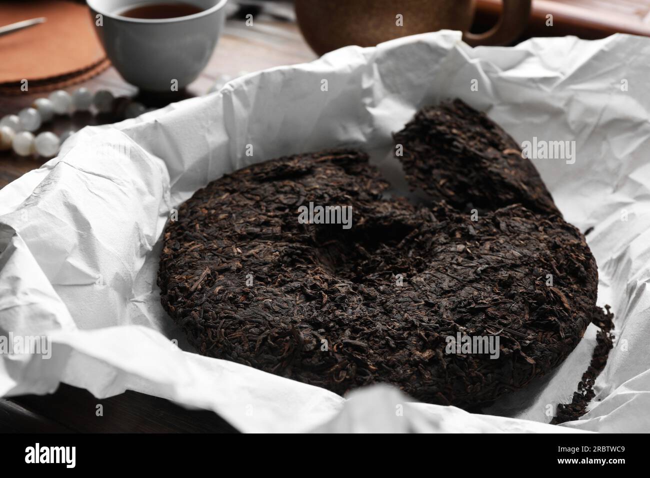 Broken disc shaped pu-erh tea on parchment paper Stock Photo - Alamy