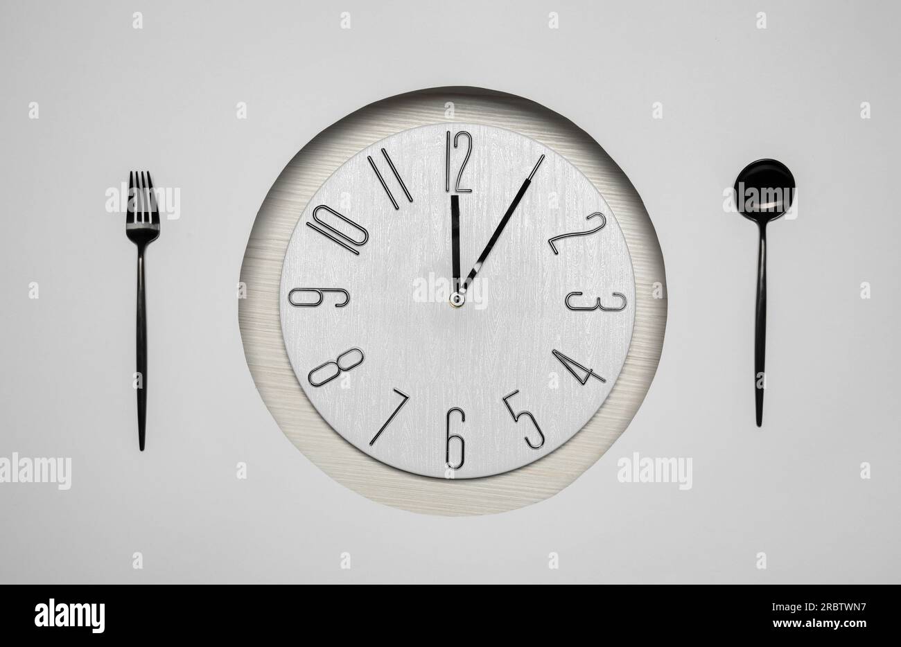 Creative business lunch layout. Composition with clock and cutlery on ...