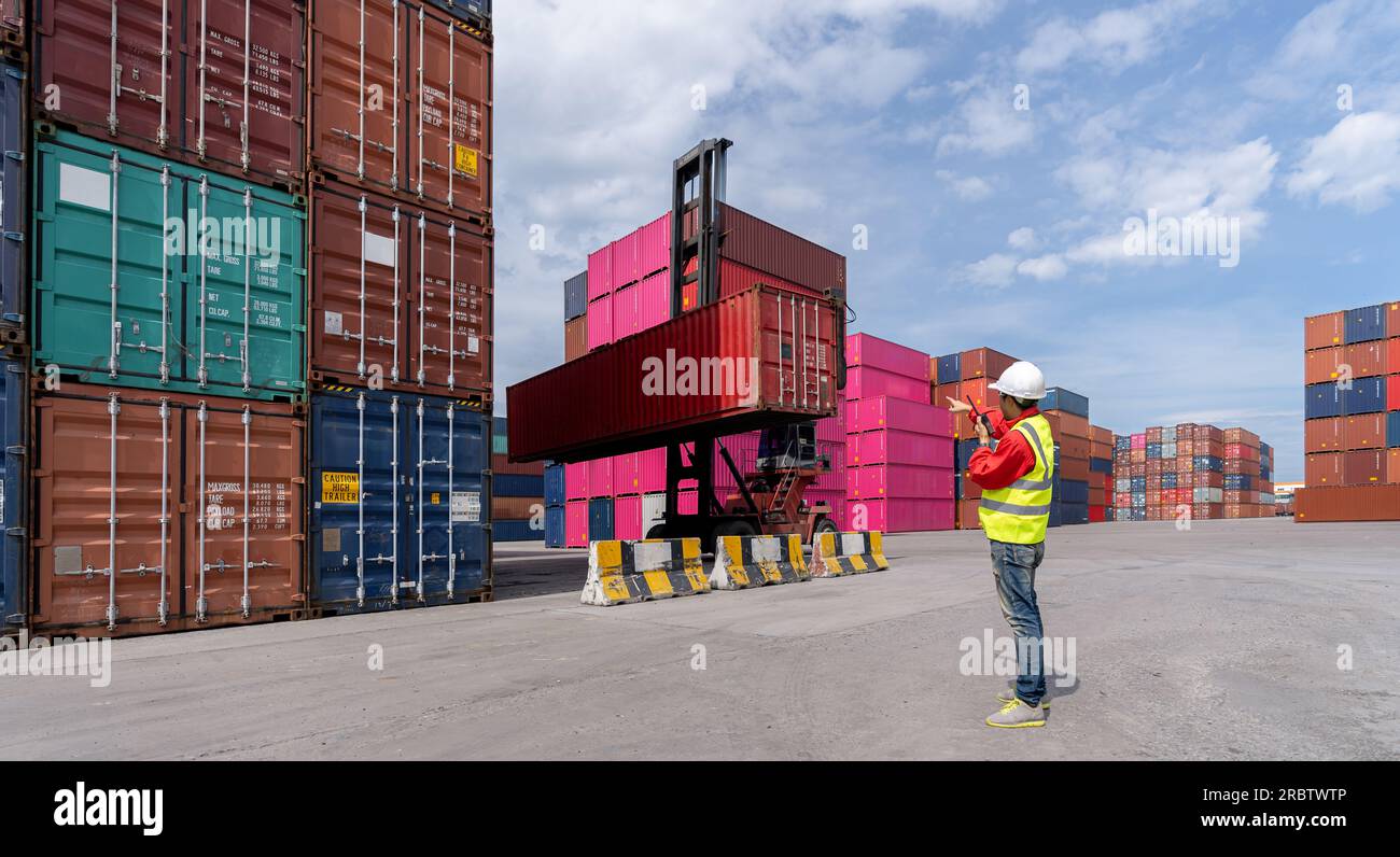 Foreman control loading Containers box from Cargo freight ship for ...