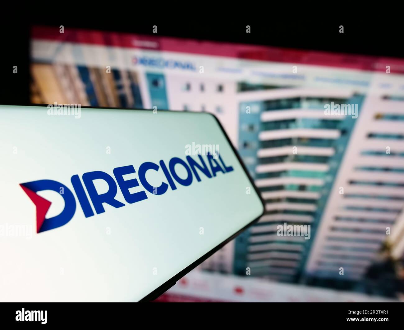 Cellphone with logo of construction company Direcional Engenharia S.A ...