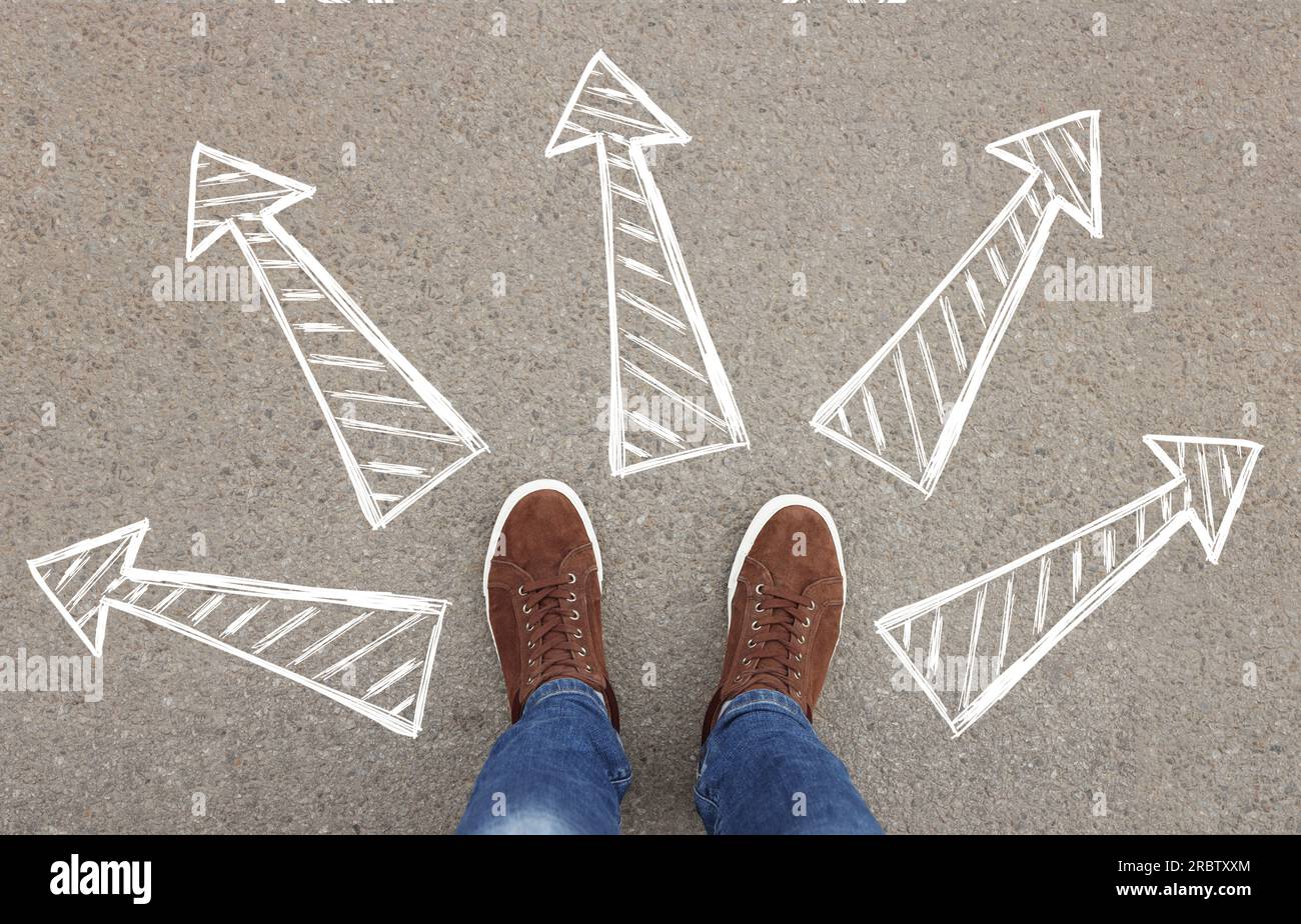 Choosing future profession. Man standing in front of drawn signs on ...