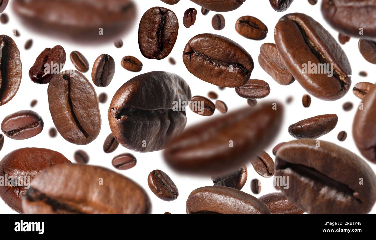 Roasted coffee beans falling o white background Stock Photo - Alamy
