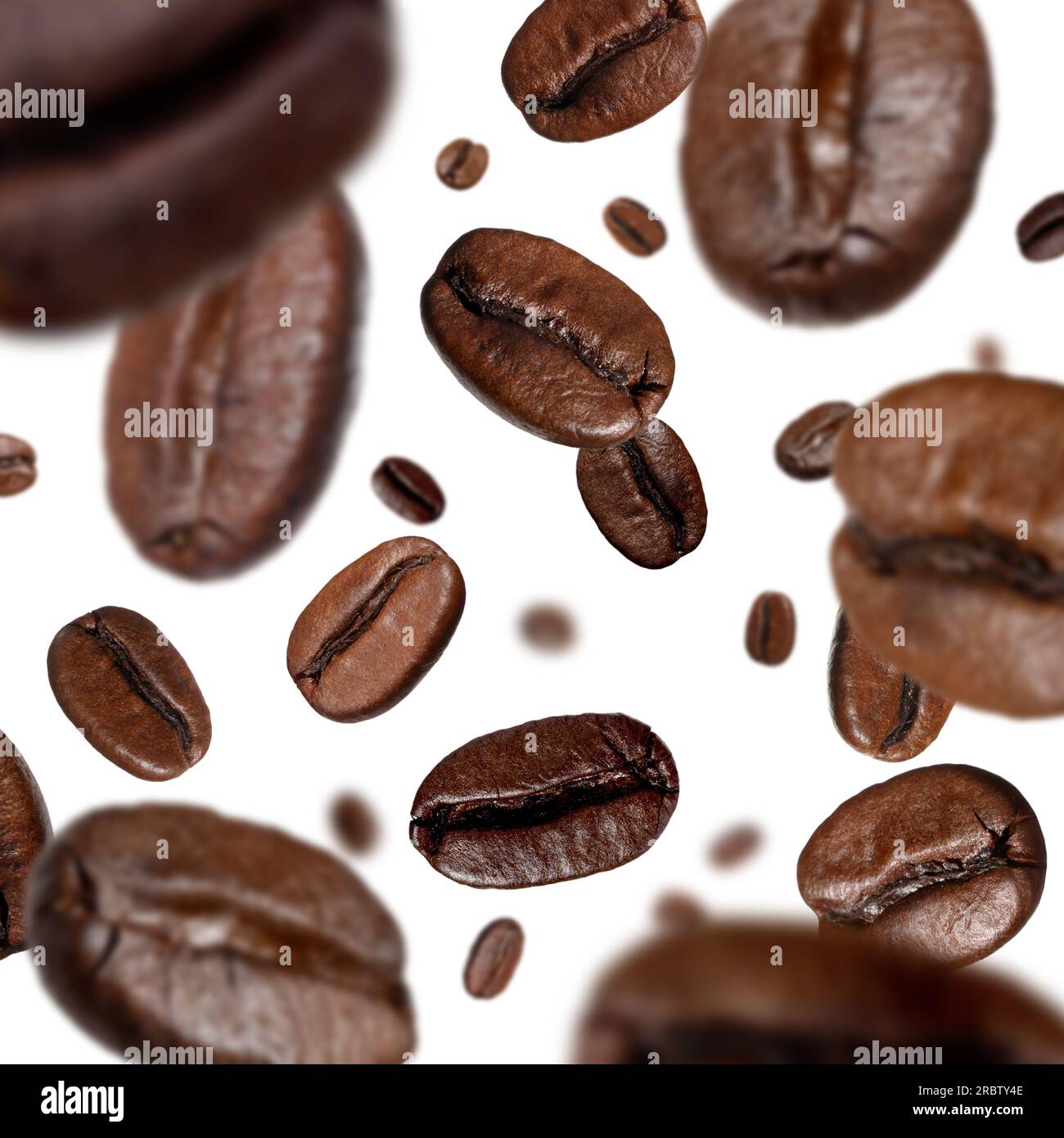 Roasted coffee beans falling o white background Stock Photo - Alamy