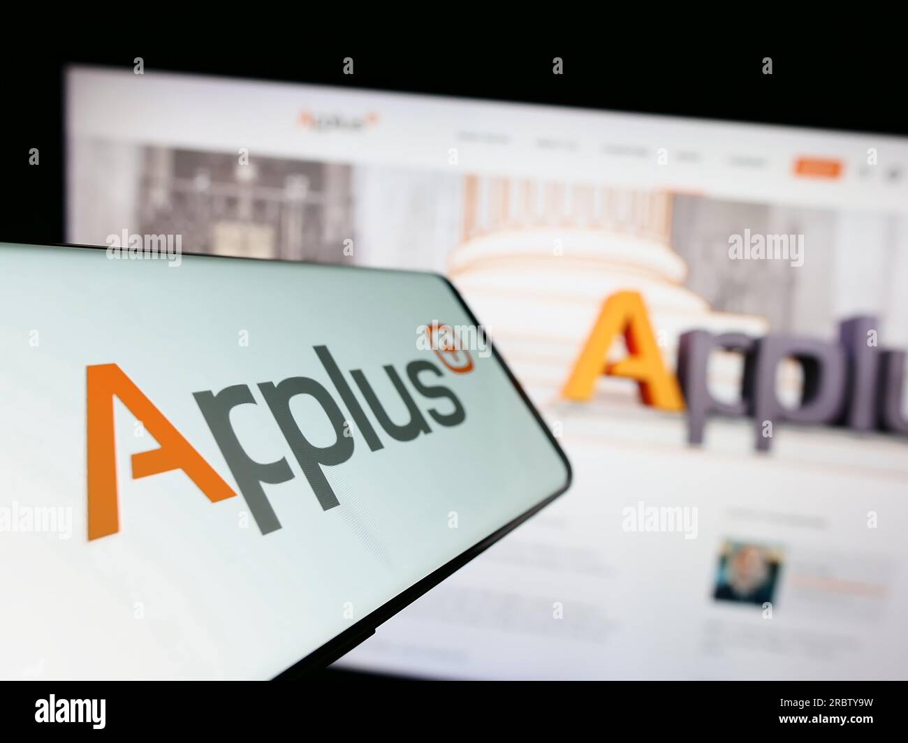 Mobile phone with logo of Spanish company Applus Services SA on screen ...
