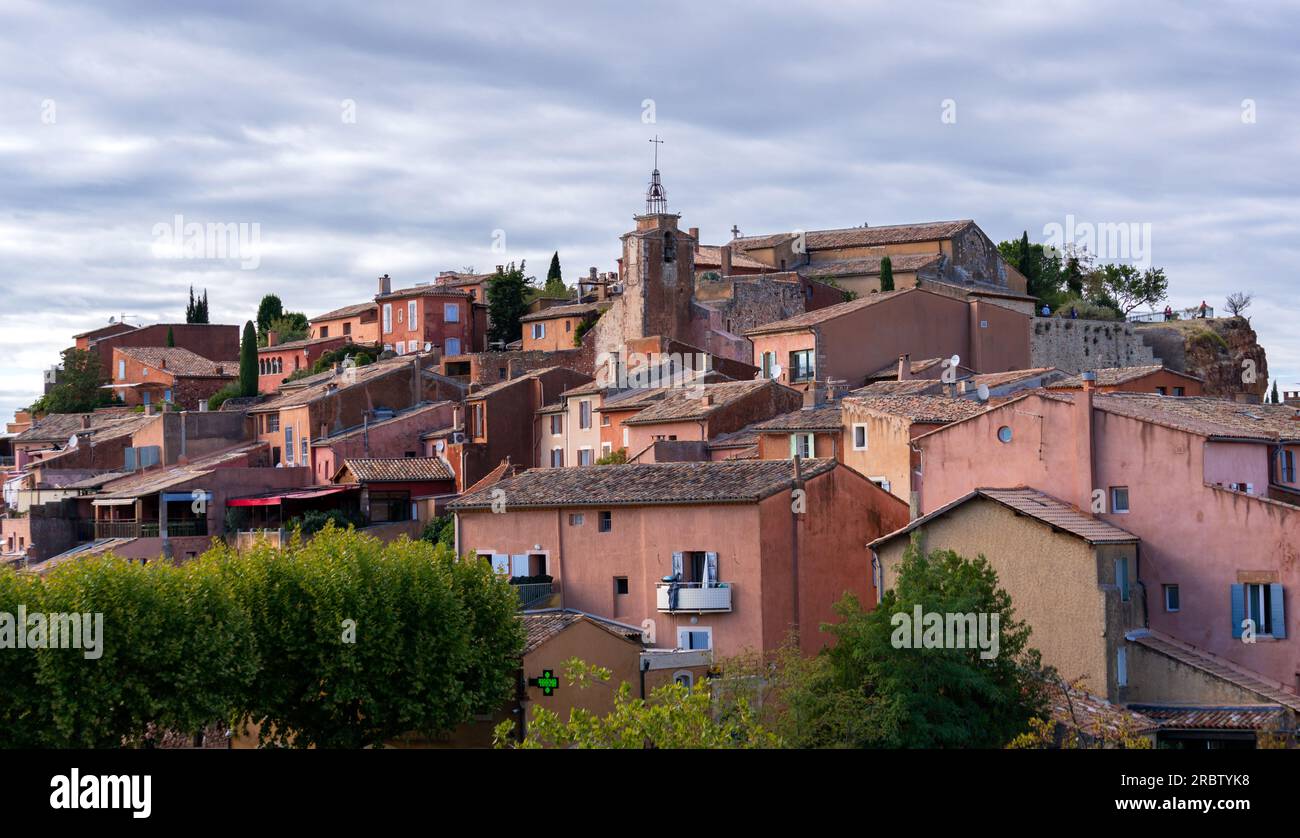 The beautiful small village of Roussillon with the buildings colored in ...