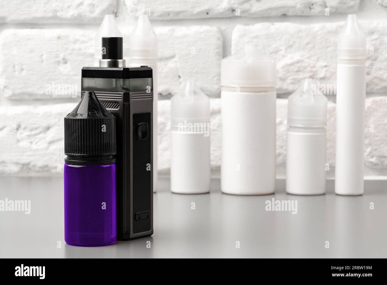 Refill liquid for electronic cigarettes against brick wall background ...