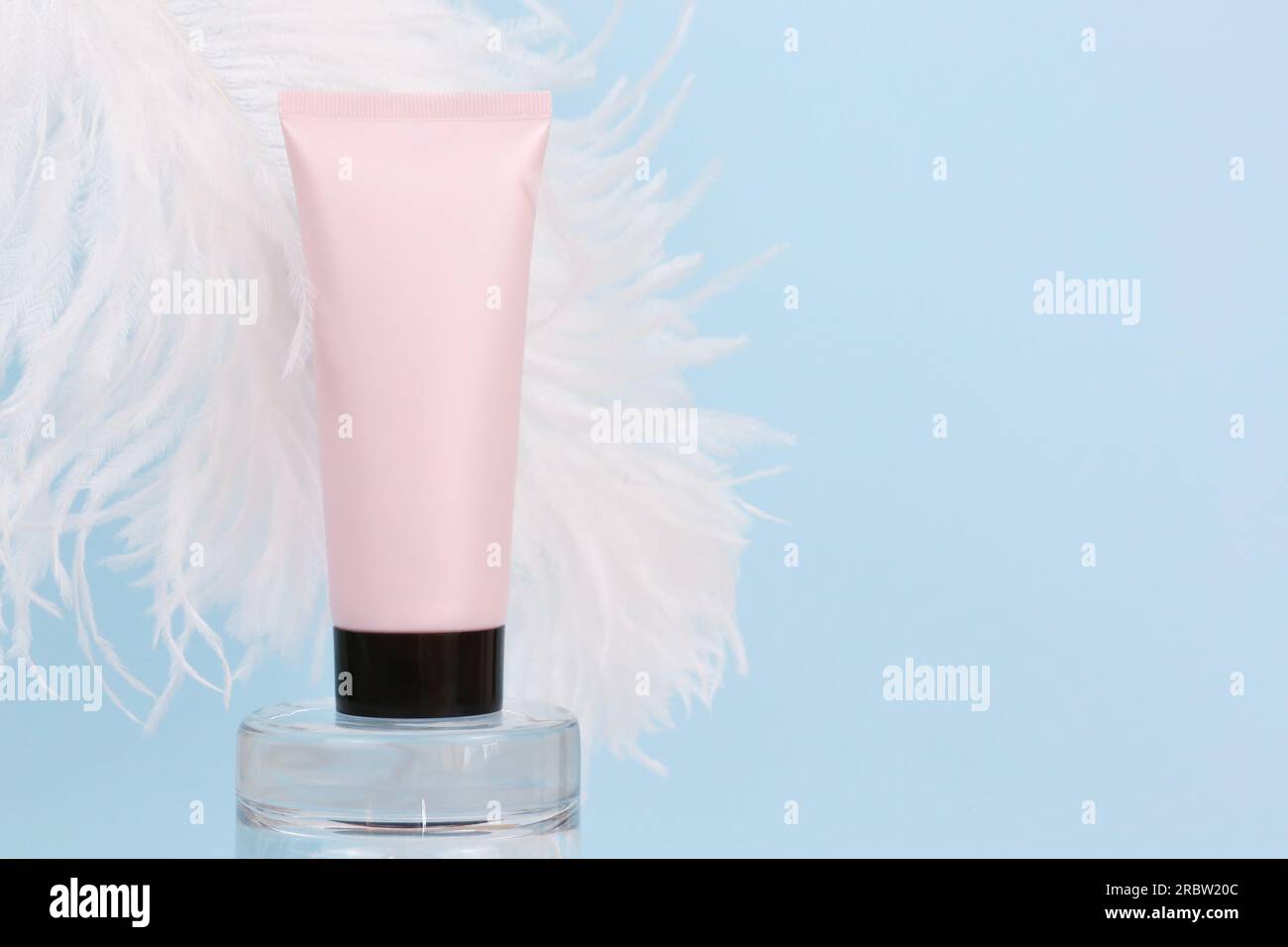 Pink squeeze bottle cosmetic tube with black cap and large white ...