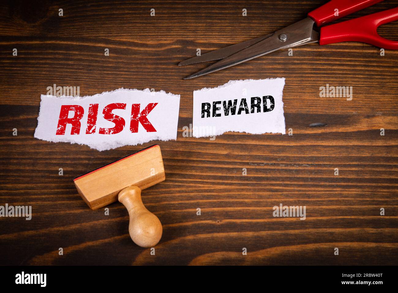 Risk vs Reward Concept. Cut sheet of paper on wood texture background ...