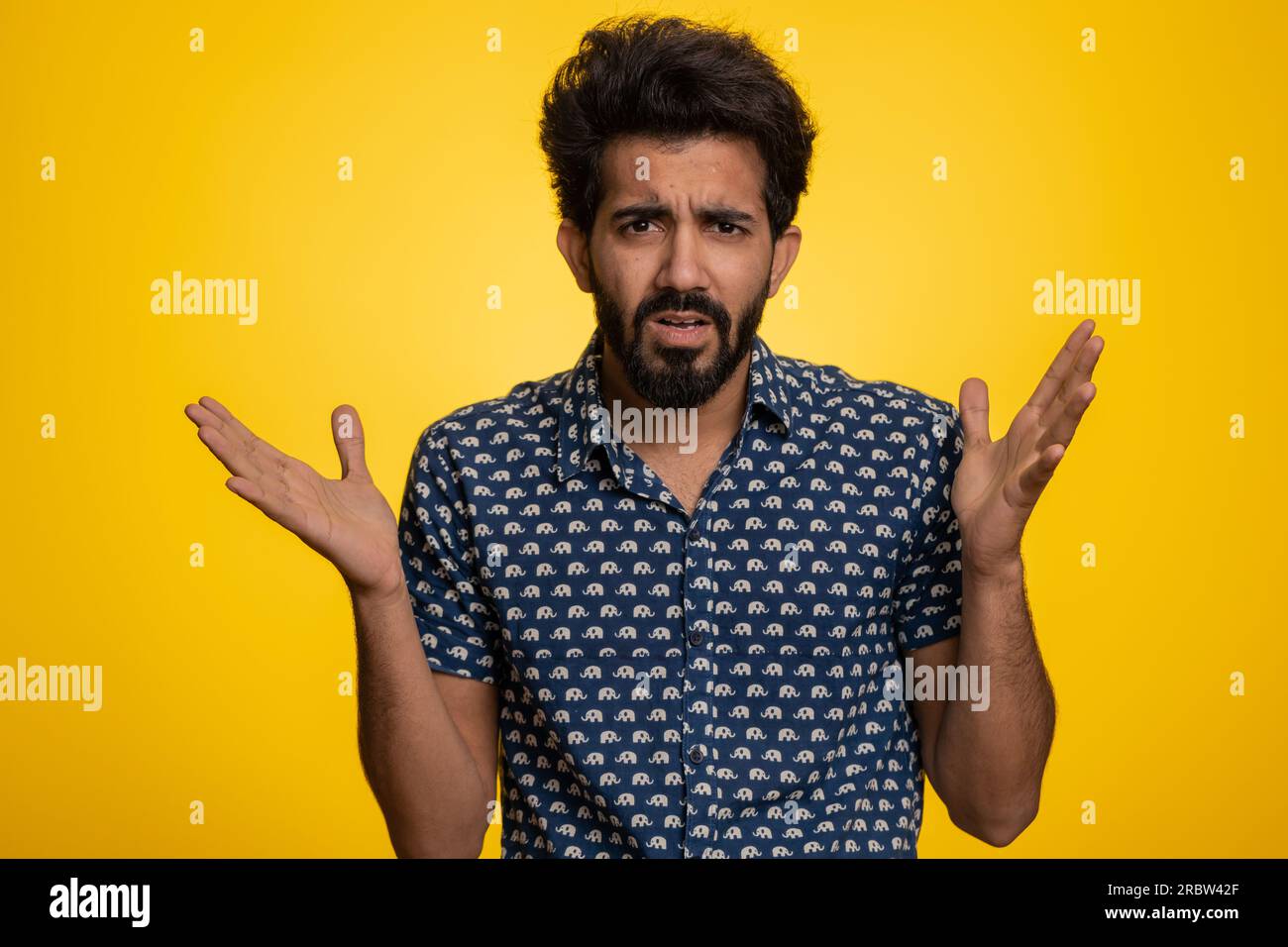 What Why. Sincere irritated indian man raising hands in indignant ...
