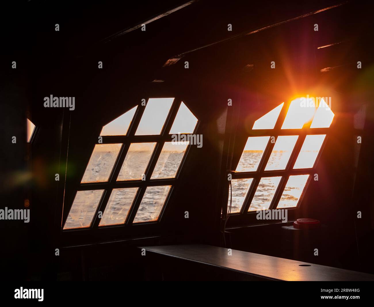 Sailboat cabin sunset sunbeams from window sailing on the sea waves ...