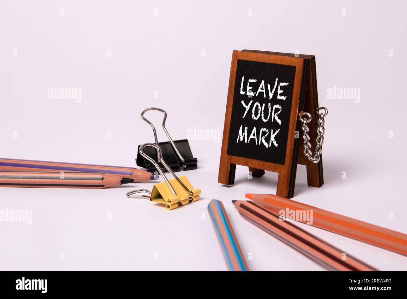 Leave Your Mark. Miniature chalkboard with text on a white office table ...