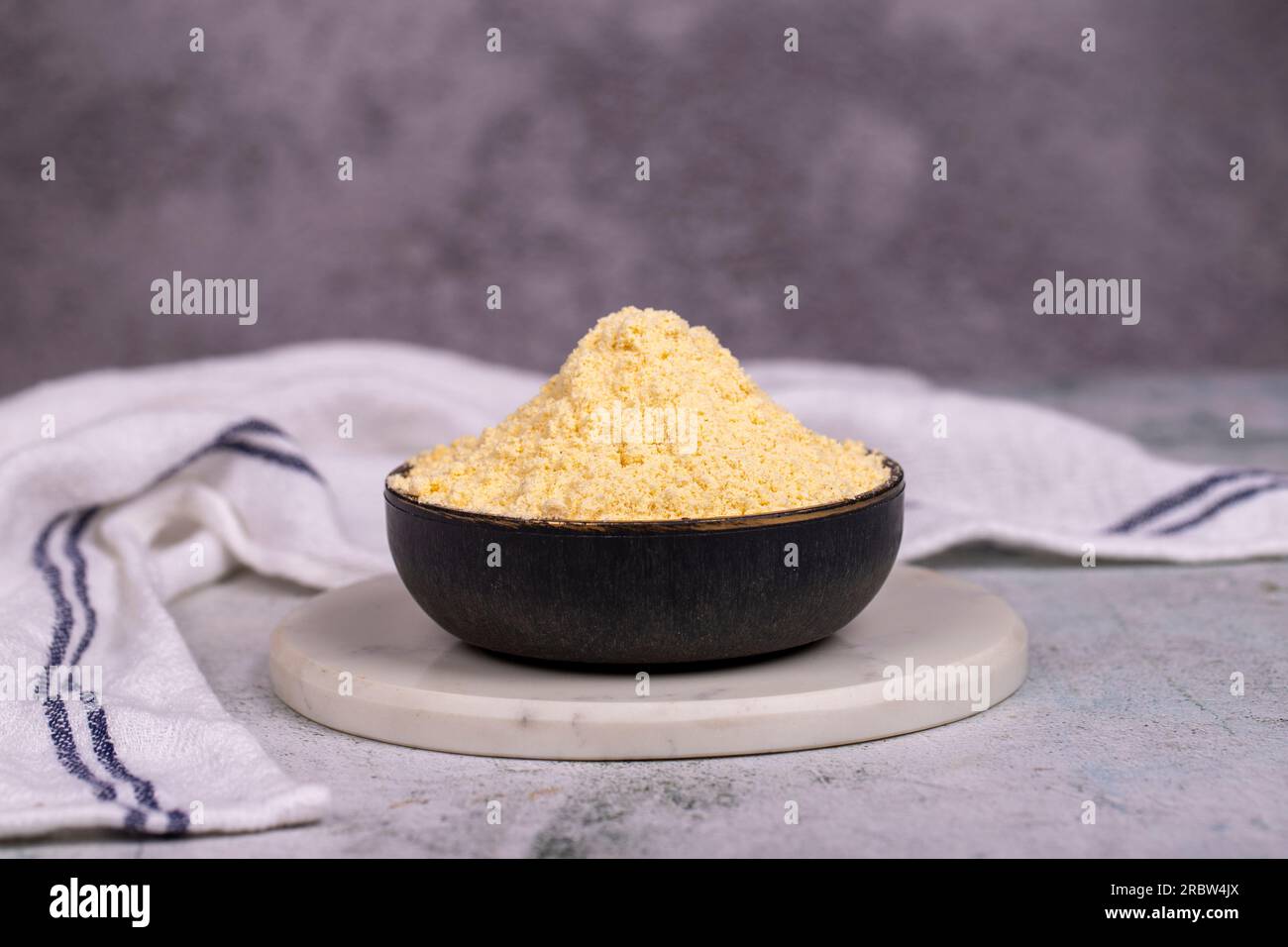 Corn flour on stone background. Cornmeal in bowl. close up Stock Photo ...