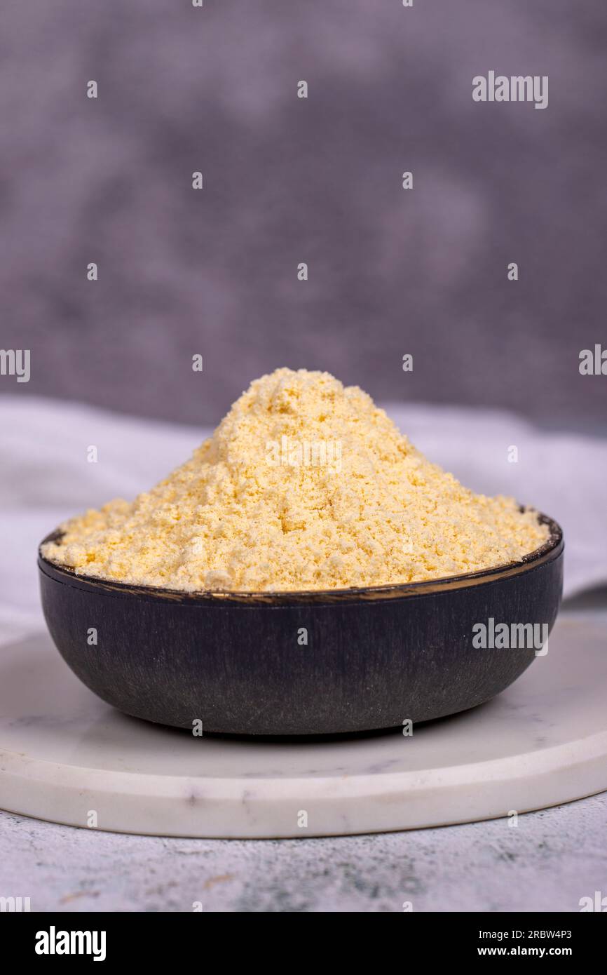Corn flour on stone background. Cornmeal in bowl. close up Stock Photo ...
