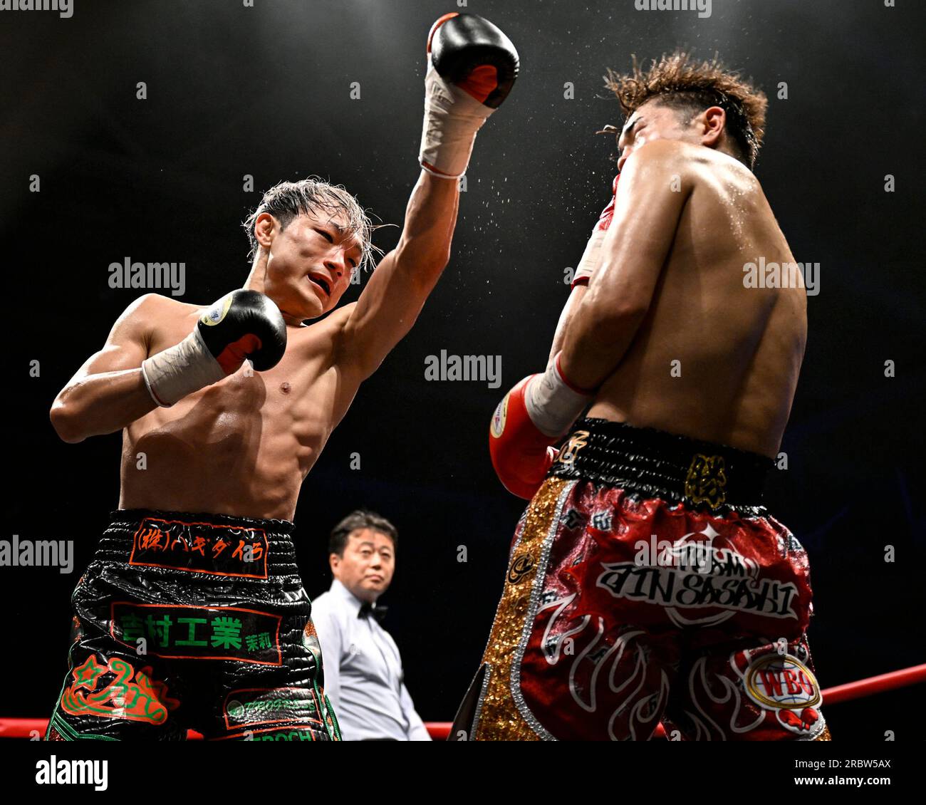 Jin Sasaki (red gloves) and Hiroto Hoshi (black gloves) compete during ...