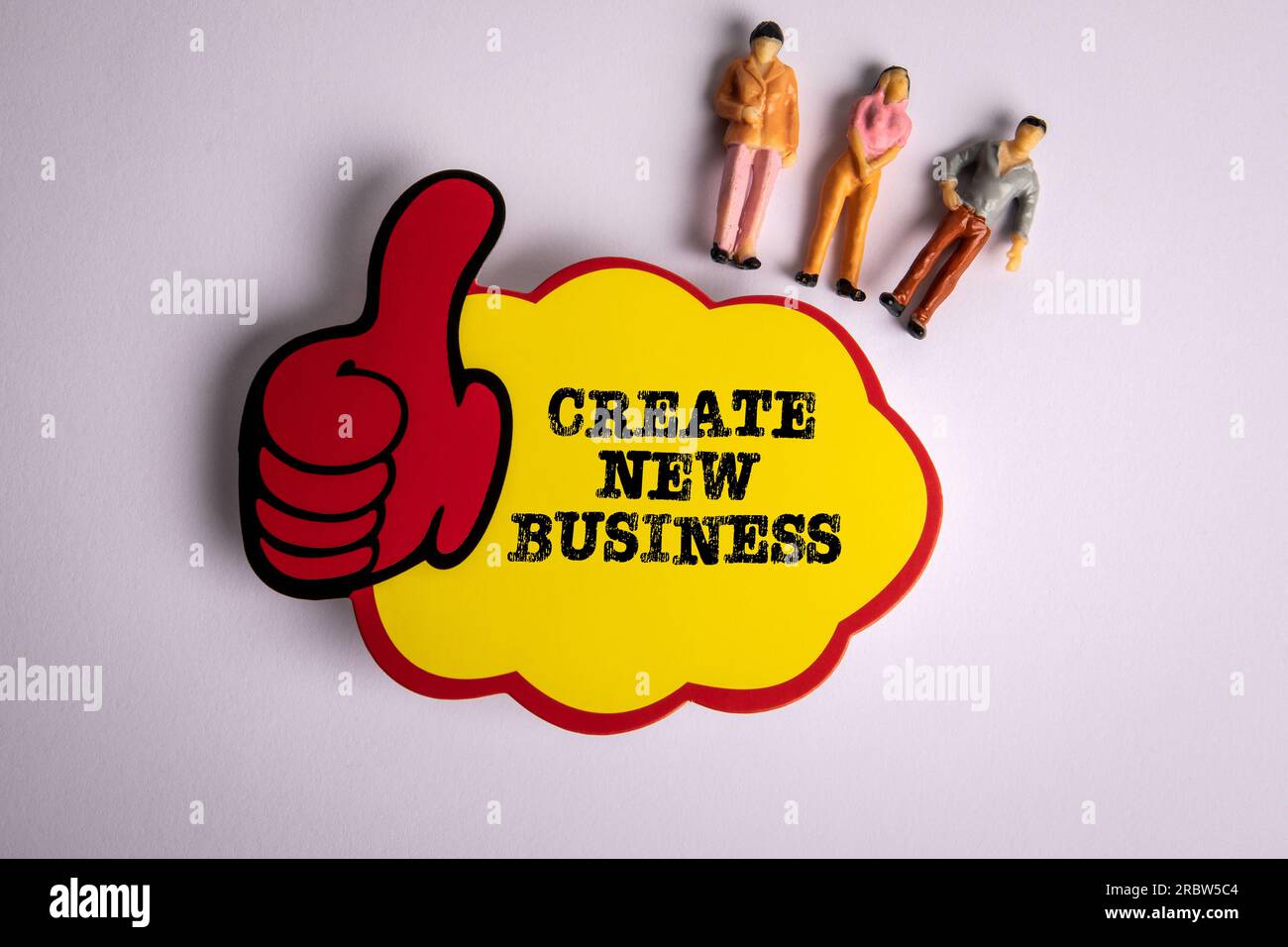 Create new business concept. Miniature human figures on a white ...
