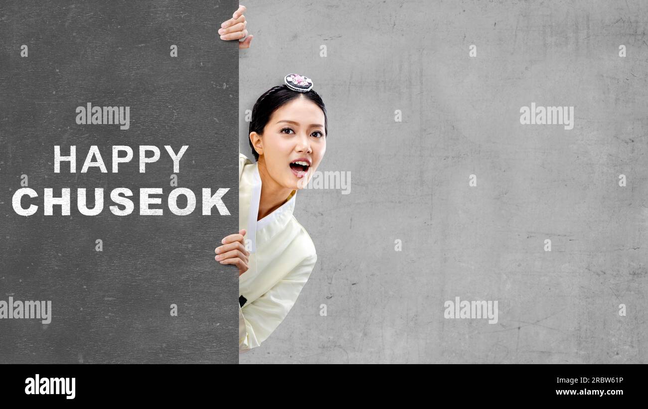 Asian woman wearing a traditional Korean national costume, Hanbok, showing a greeting of Happy ...