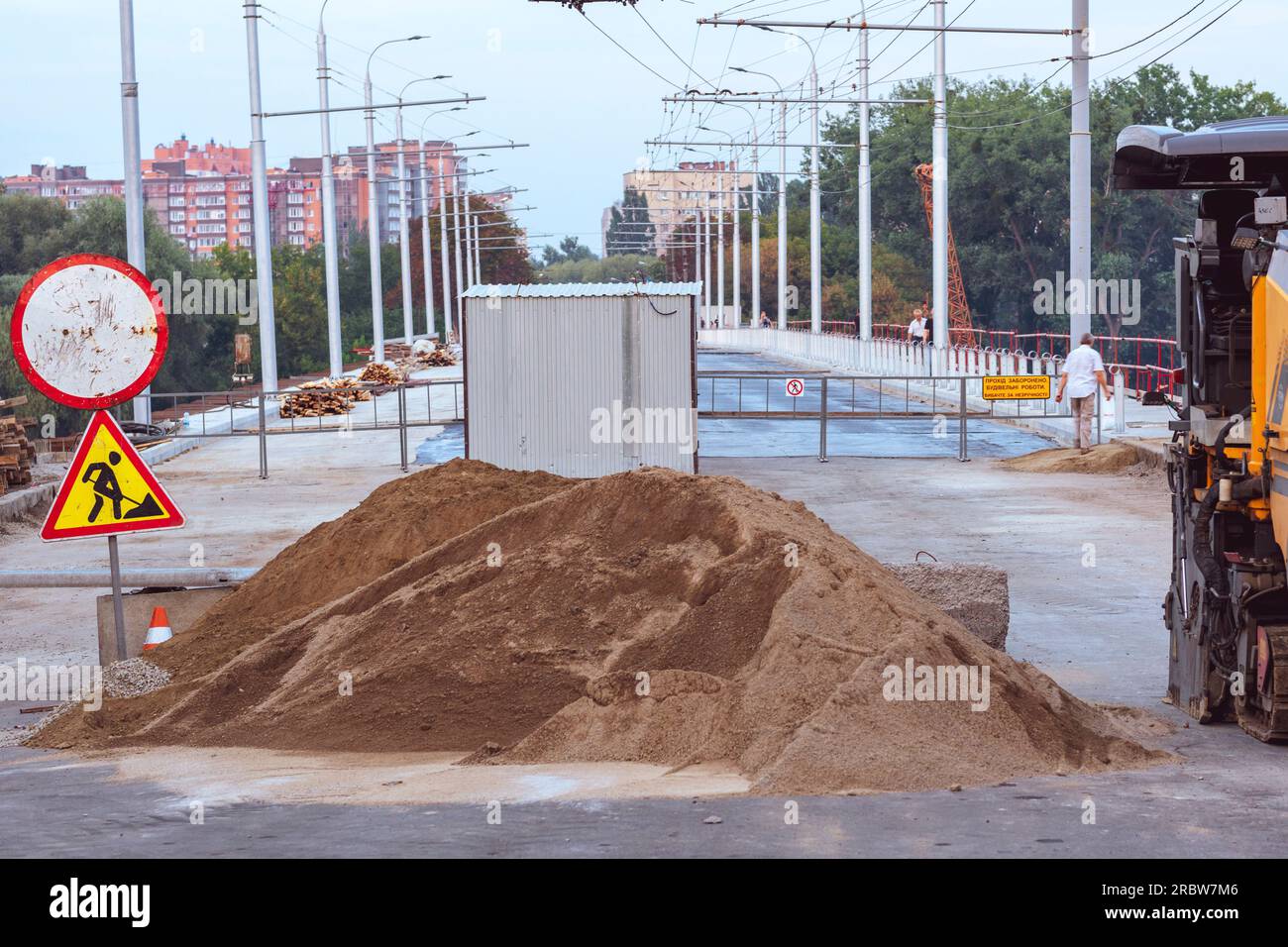 Pile of sand.Heap of sand. Road signs. Carrying out repair work on the ...