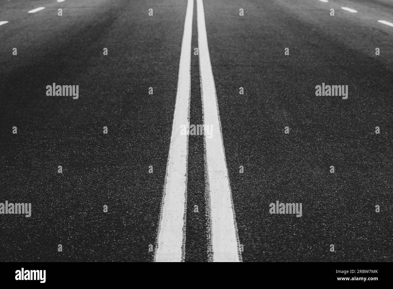 The asphalted road with two continuous white strips. The highway with a ...