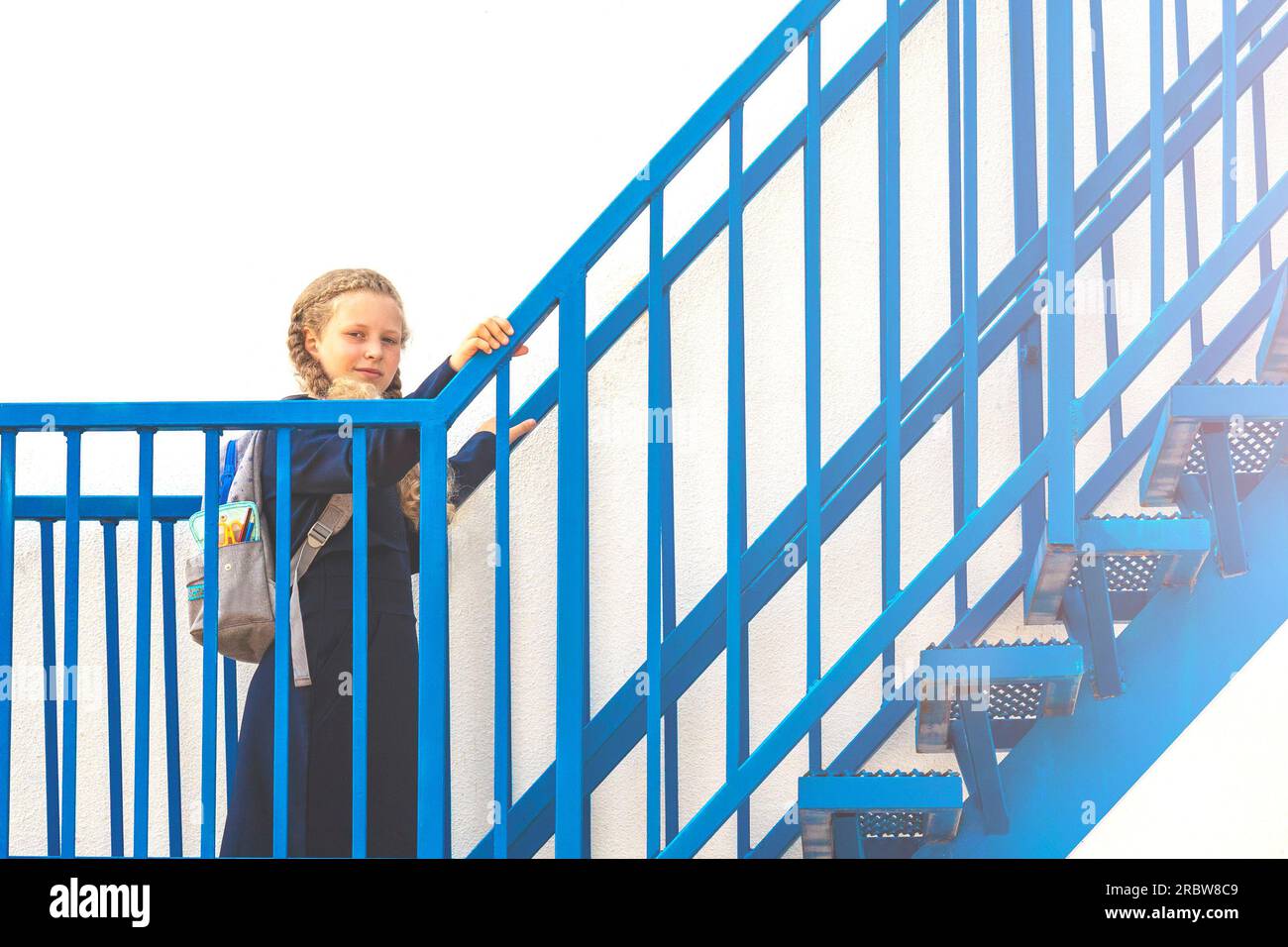 Schoolgirl climbs the stairs. Concept school days, start date, next ...