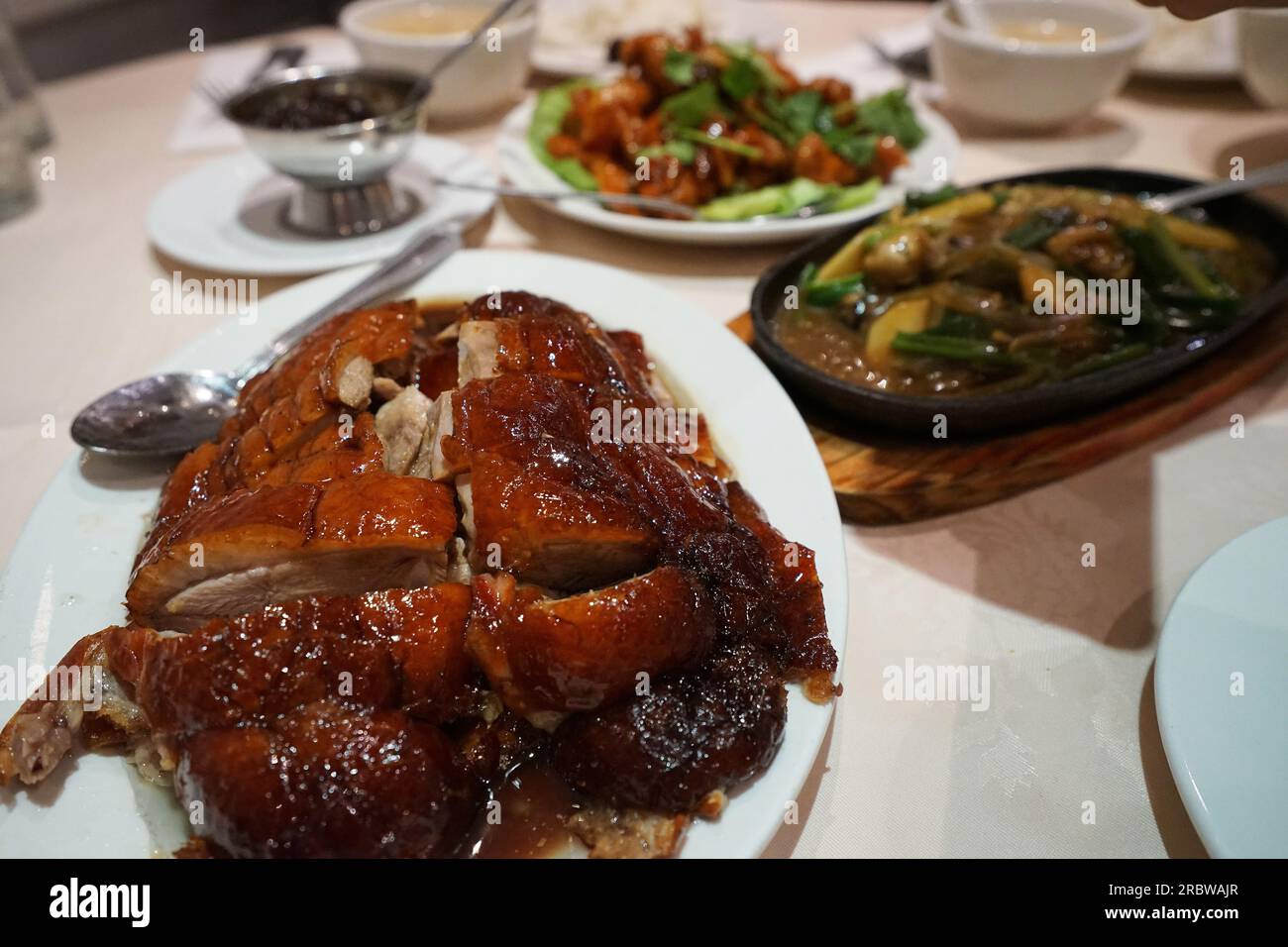 Close up Chinese roasted honey duck with stir fry vegetables and orange ...