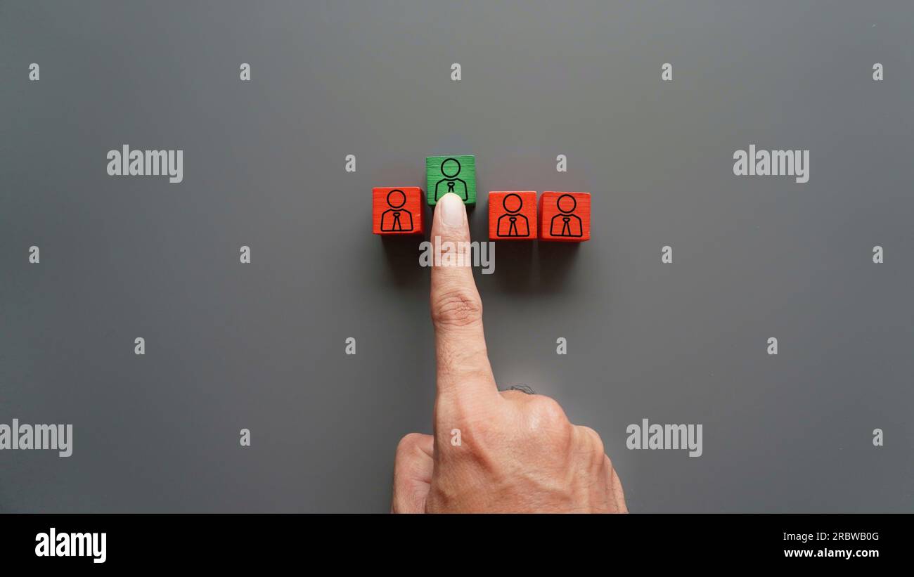 Hand choose green wooden cube with people icon. Choosing, finding right ...