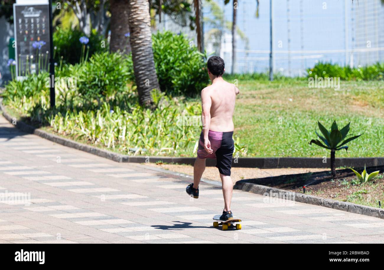 man playing sports on the boardwalk Stock Photo - Alamy