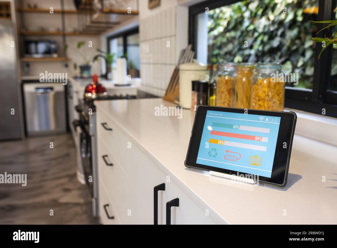 Tablet with smart home interface on white worktop in kitchen Stock ...