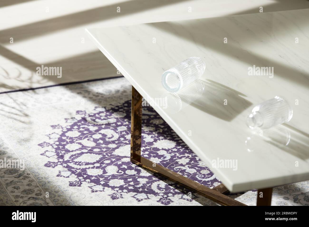 Vases and objects on the table in a warm room with sunlight coming in ...