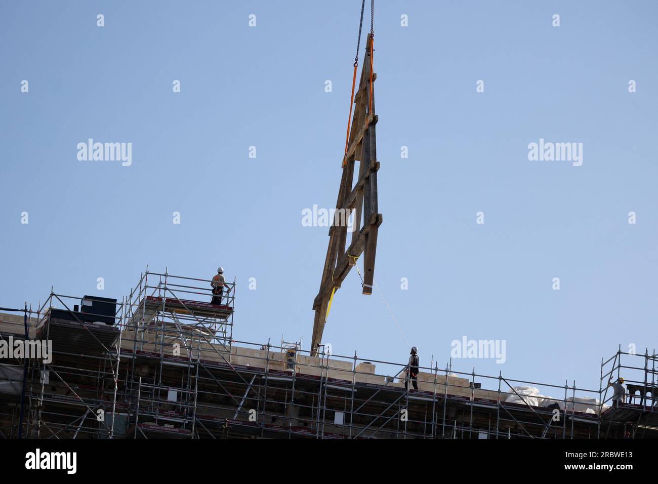 The first 15 meters long and 10 meters high timber truss is craned into ...