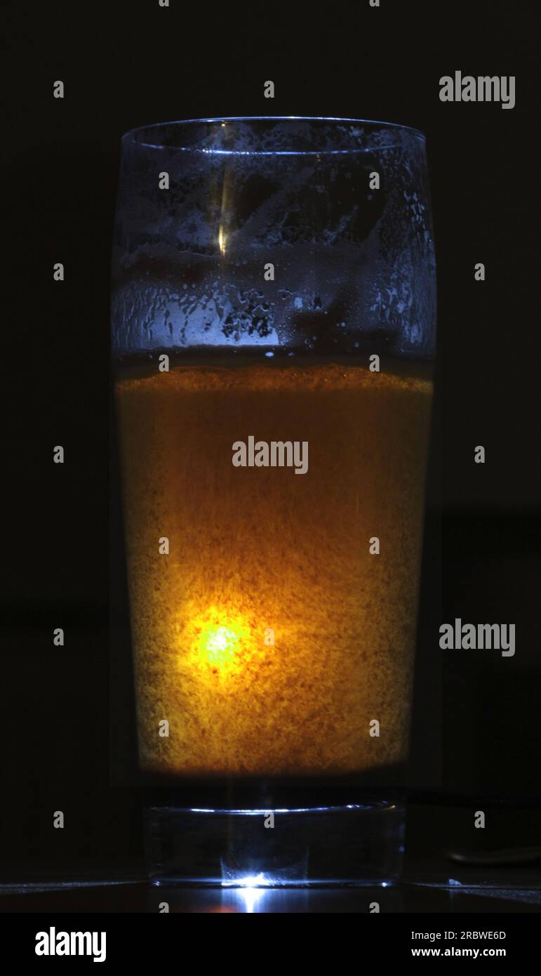A mysterious spoiled drink with a glowiung light Stock Photo - Alamy