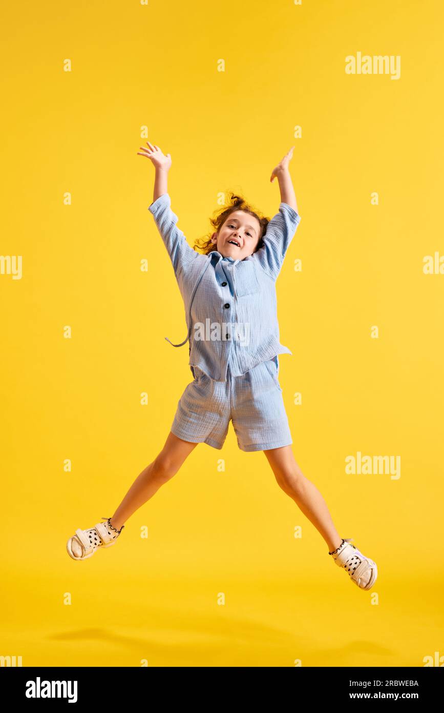Full-length portrait of positve, active little girl, child in casual ...