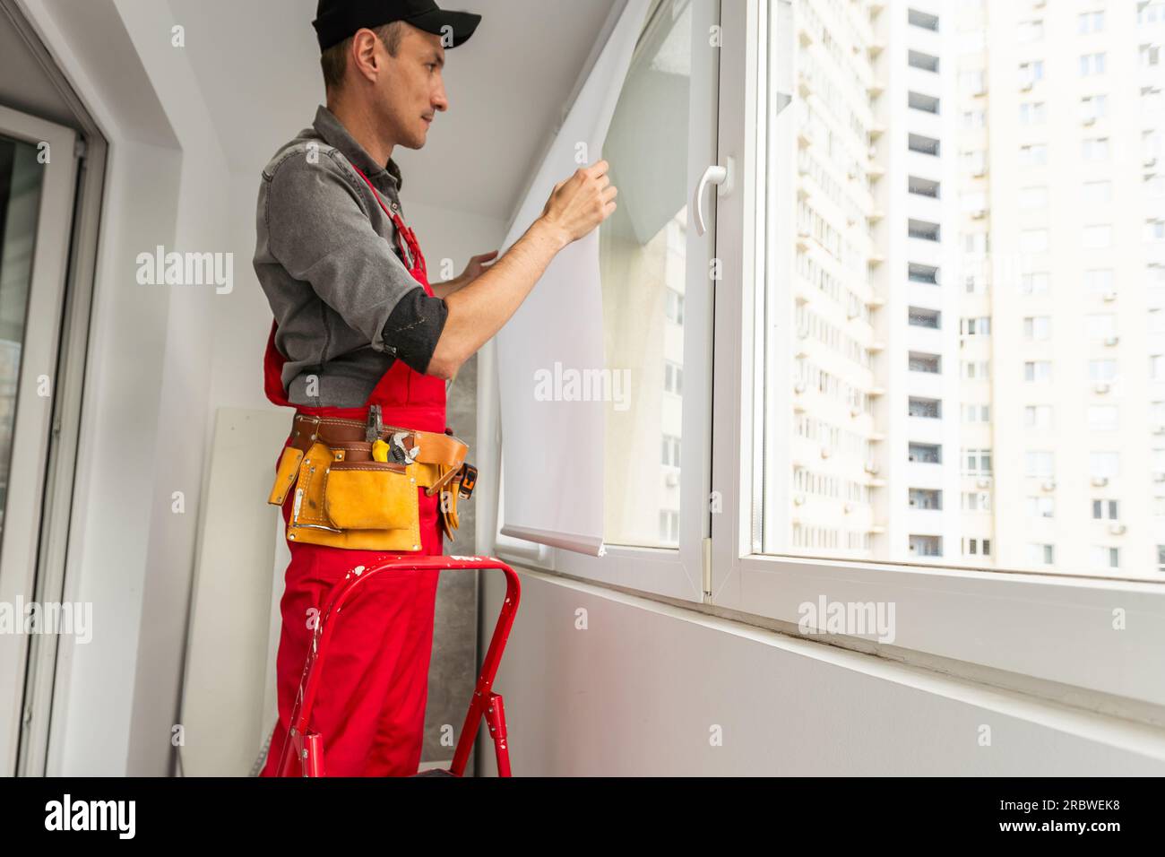 Construction worker installing new window in house Stock Photo - Alamy