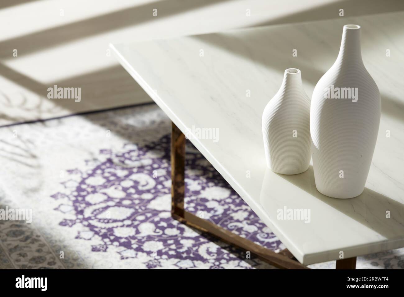 Vases and objects on the table in a warm room with sunlight coming in ...